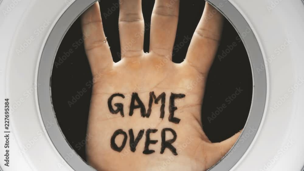 hand with the inscription on the palm: game over, appears in the ...