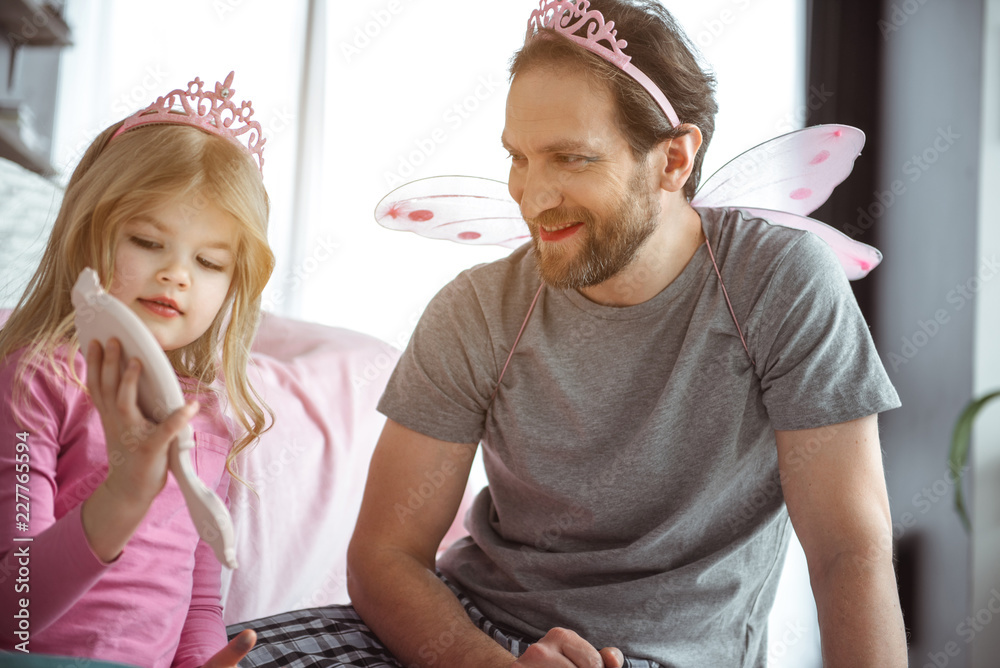 How pretty I am. Excited man is looking at his reflection in mirror. He ...