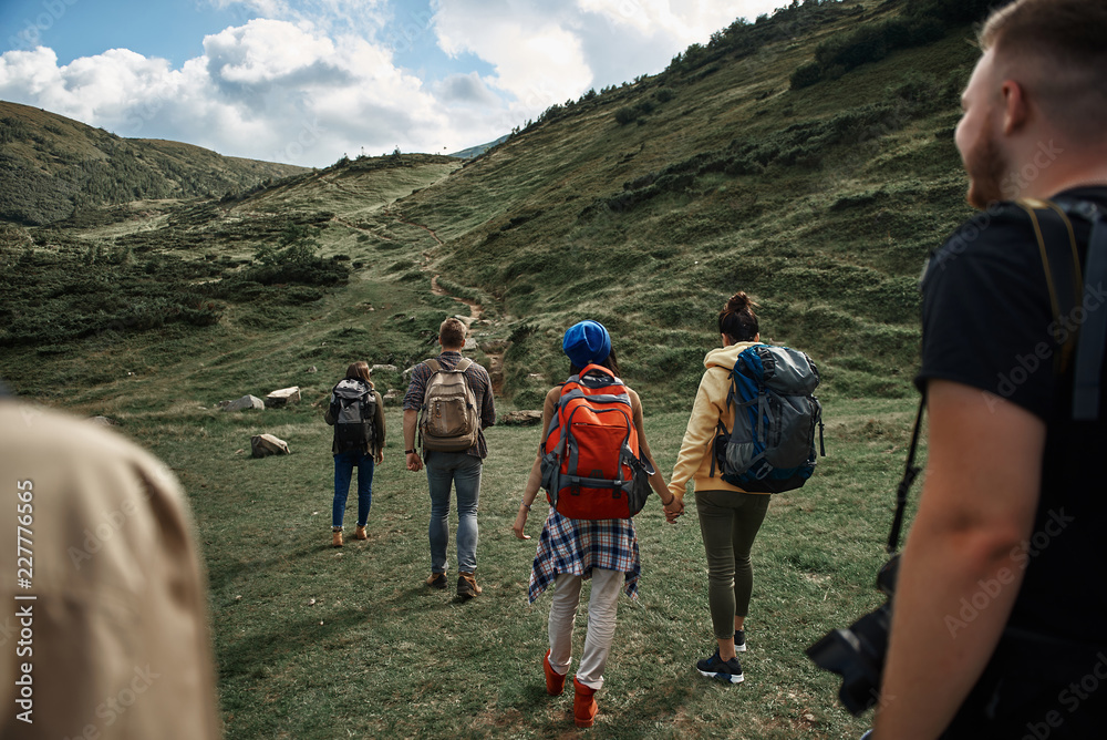 Foto de Group of six hikers climbing on peak together. They carrying ...