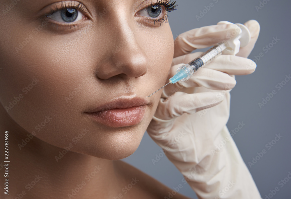 Necessary injection. Calm lady waiting and looking calm during the ...