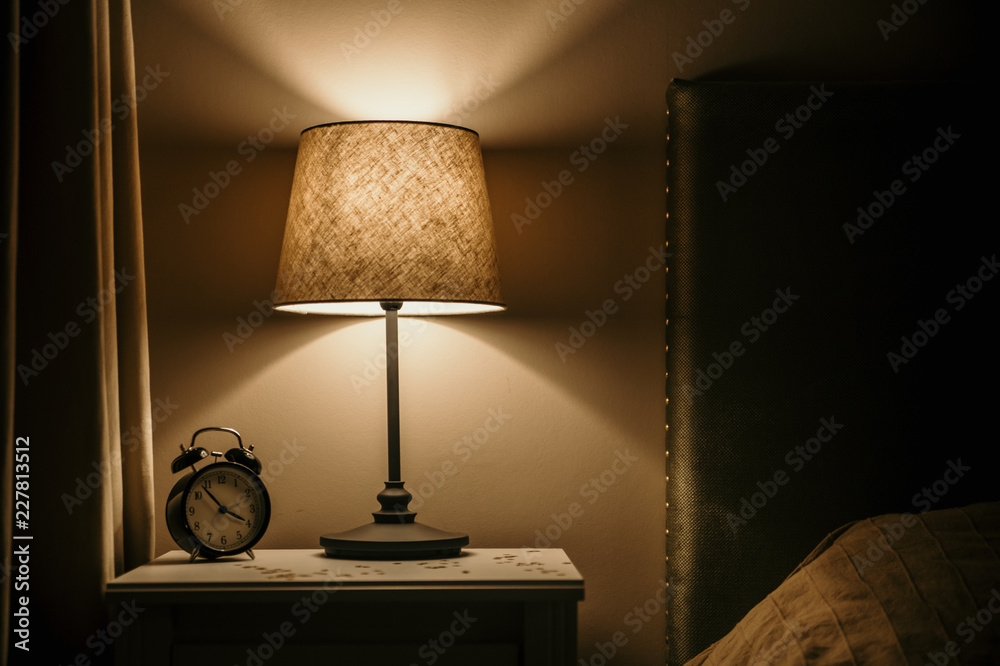 night light and alarm clock on the bedside table Stock Photo | Adobe Stock