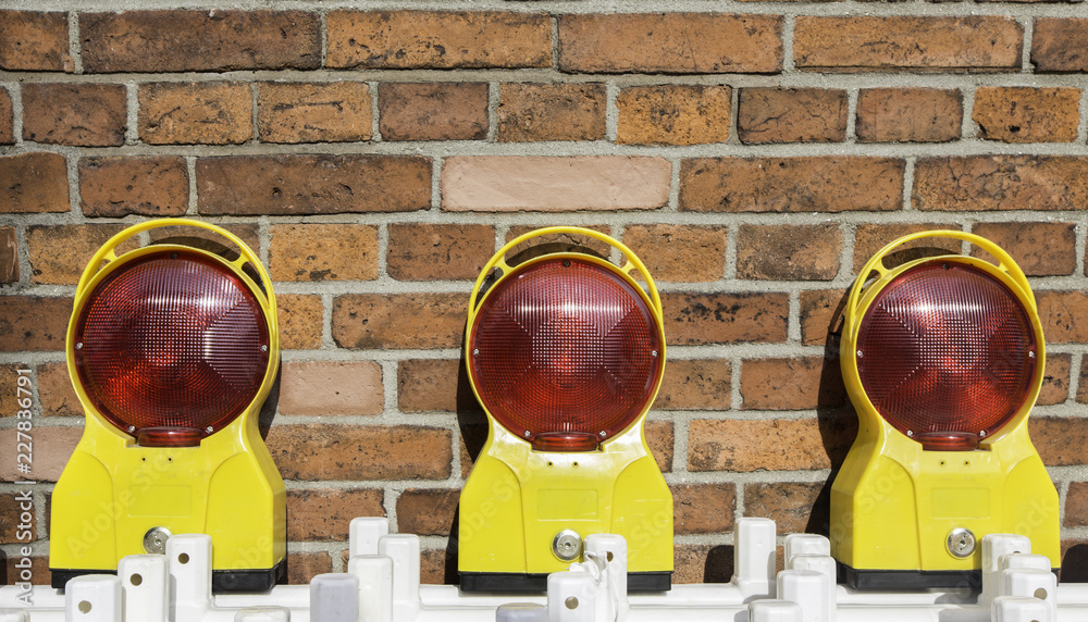red warning road reflectors, brick wall background Stock Photo | Adobe ...