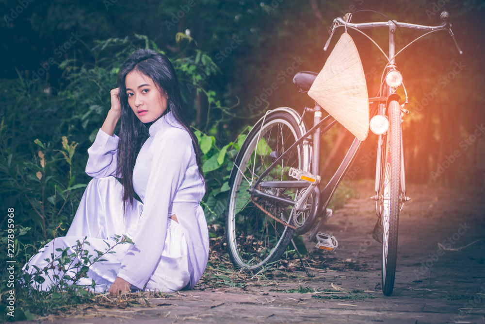 Portrait Of Young Asian Girl With Long Hair Wearing A Dress Of Vietnam