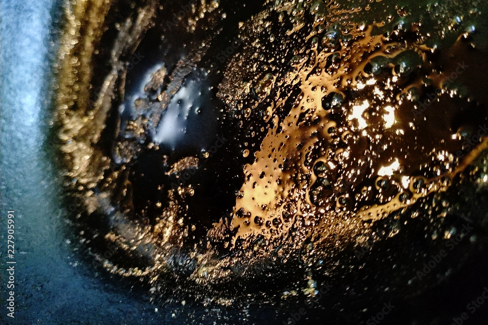 Frying pan with a pattern of grease and oil stains. Dark background ...