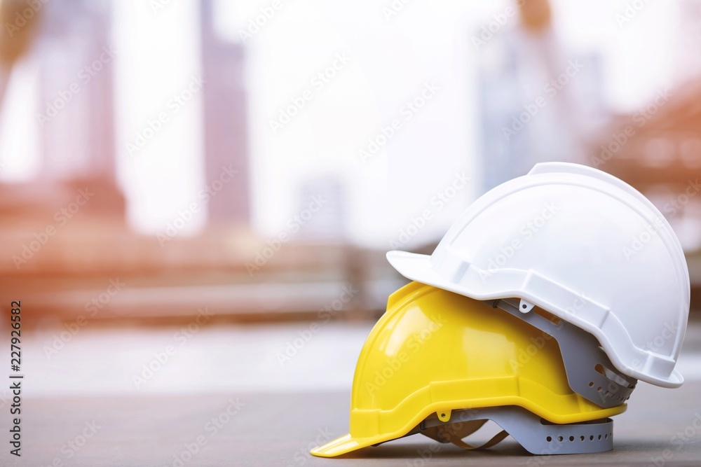 yellow and white hard safety wear helmet hat in the project at ...