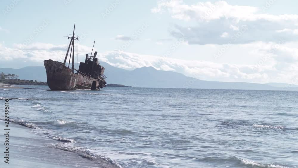 An old abandoned shipwreck, wrecked boat sunken ship stand on beach ...