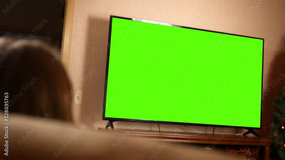 Woman watches a green screen 4K television in living room Stock Video ...