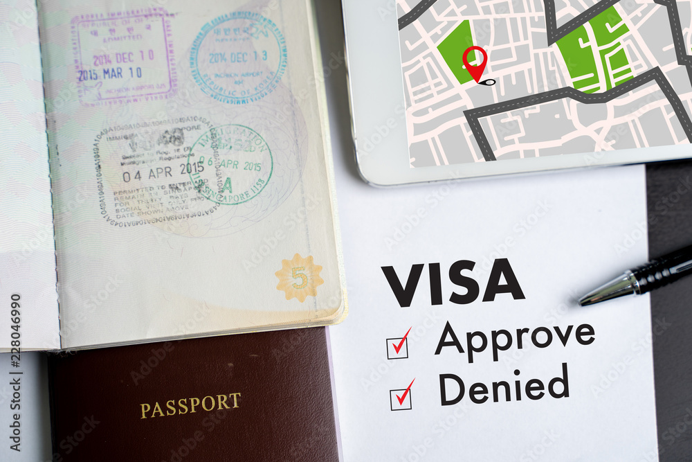Visa and passport to approved stamped on a document top view in ...