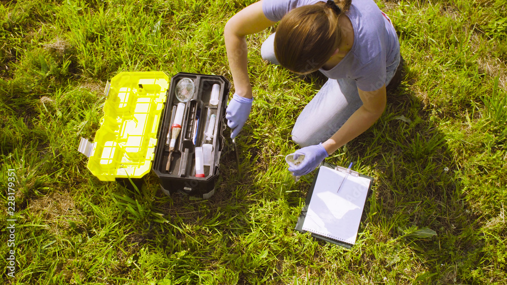 Top view. Woman ecologist getting samples of soil. Damage appreciate to ... Top view. Woman ecologist getting samples of soil. Damage appreciate to ...