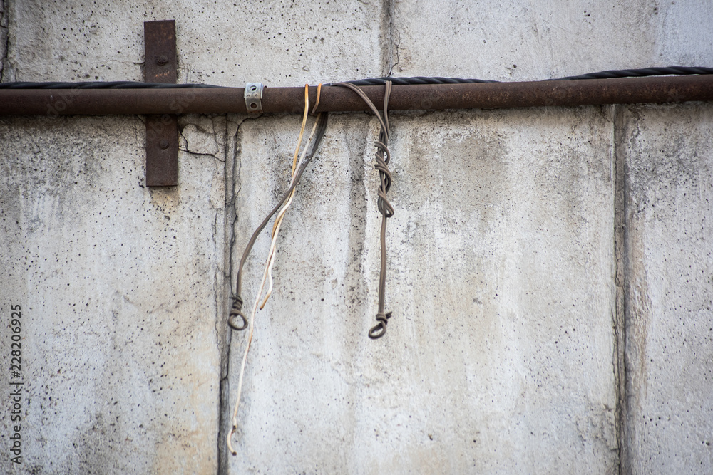 Electrical wire is attached to a metal pipe Stock Photo | Adobe Stock