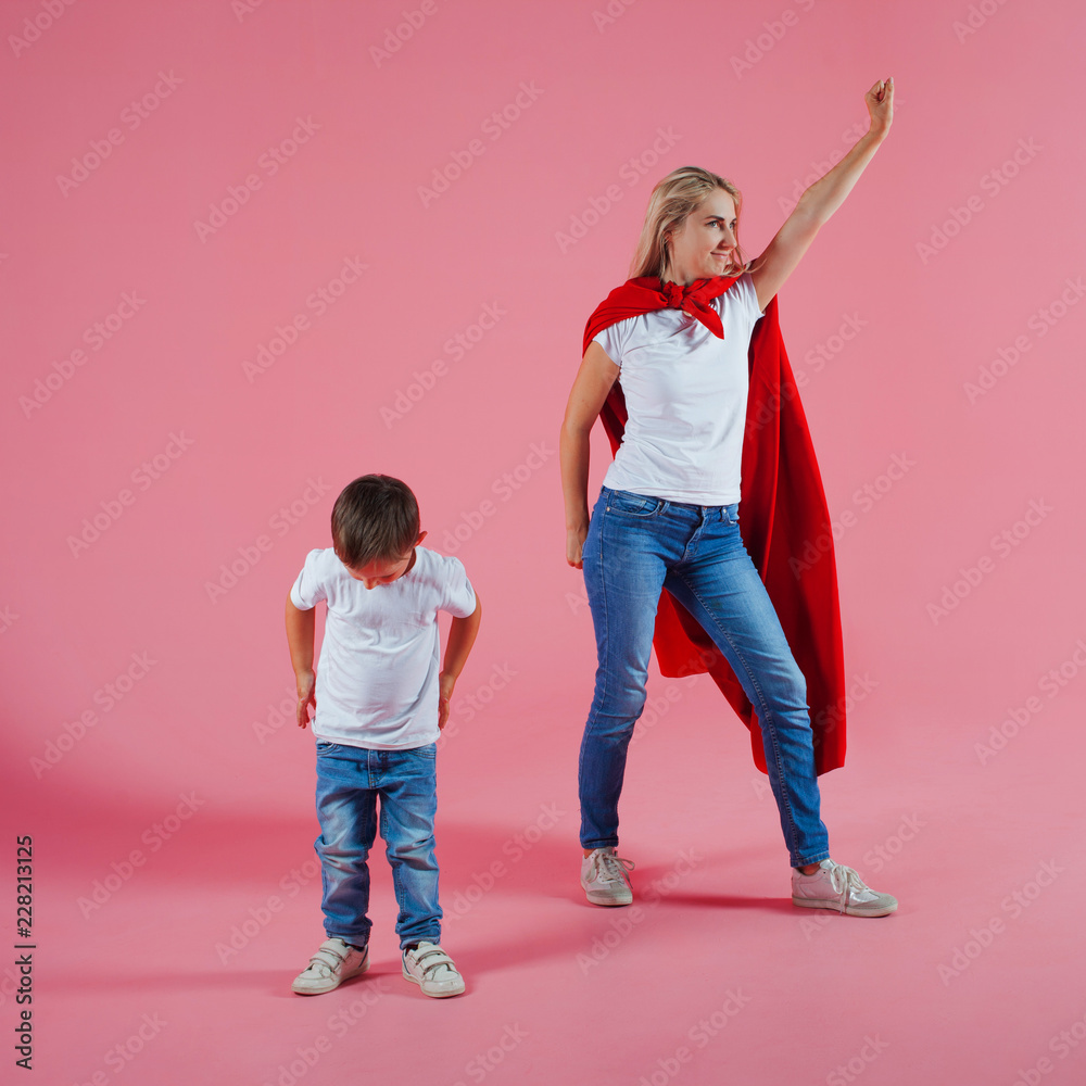 Mom is a superhero. Fun family, a young blond woman in a red Cape and ...