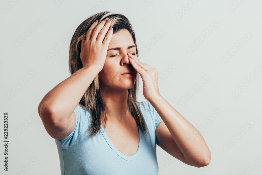 Sinus pain, sinus pressure, sinusitis. Sad woman holding her nose and ...