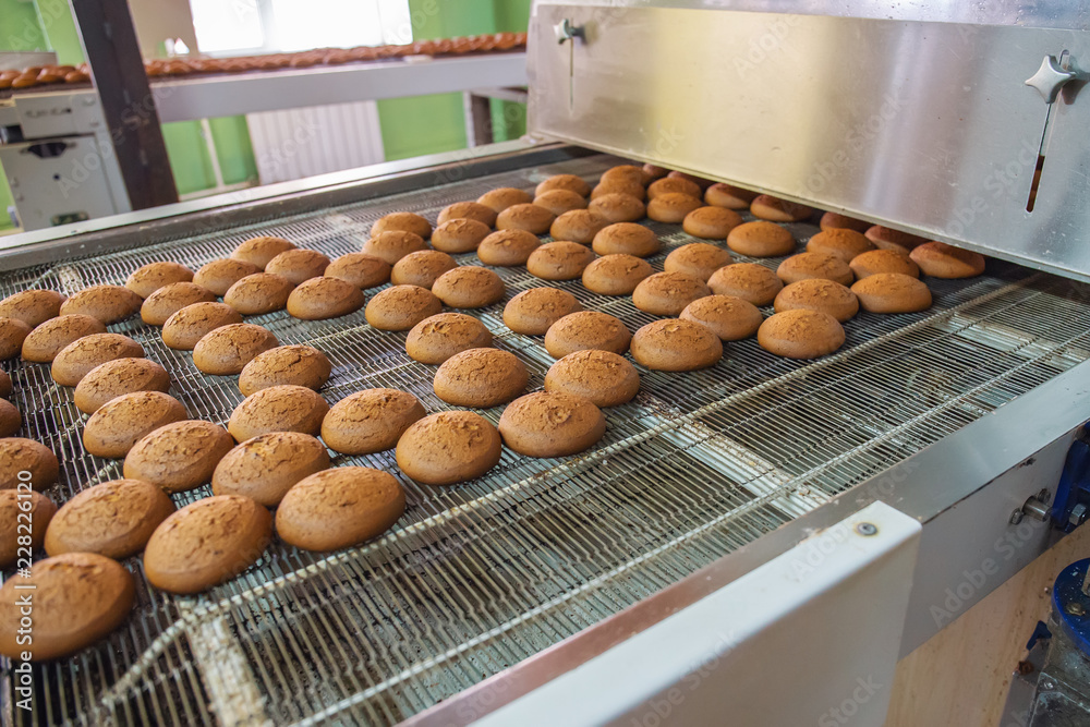 Automatic bakery production line with sweet cookies on conveyor belt ...