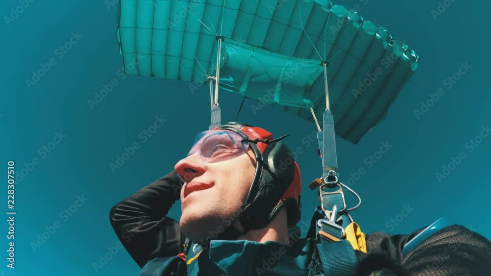 Skydivers flying in tandem under the open parachute. Tandem Skydiving ...