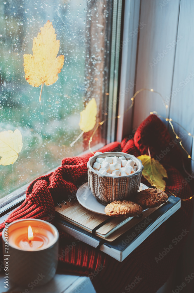 cozy autumn morning at home. Hot cocoa with marshmallows and candle on ...