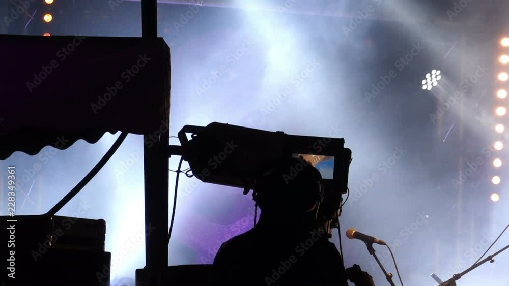 Video „A cameraman on a stage is filming a guitarist in close-up during ...