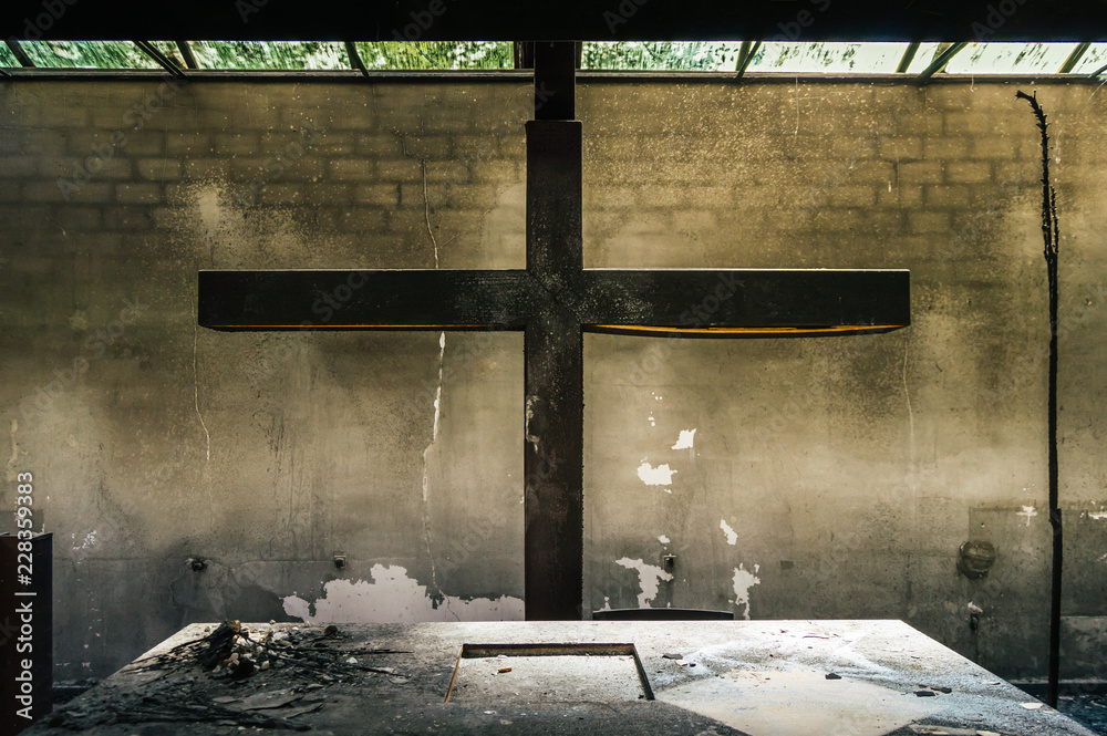 Altar and huge cross in a church or chapel destroyed by fire of a ...