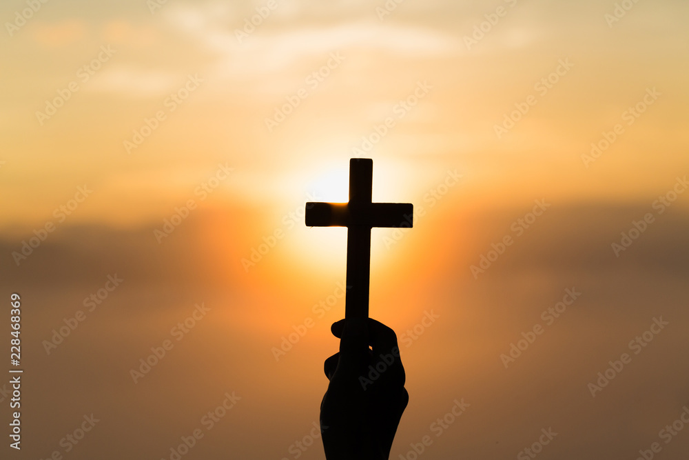Silhouette of woman hands praying with cross in nature sunrise ...