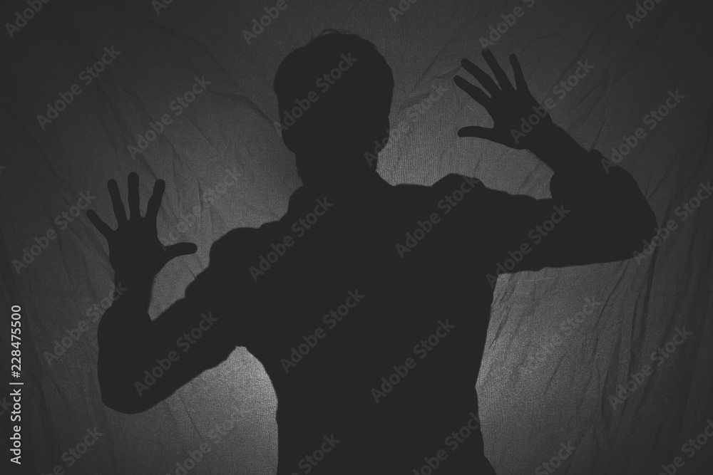 Black and white photo of shadow of a man behind the dark fabric Stock ...