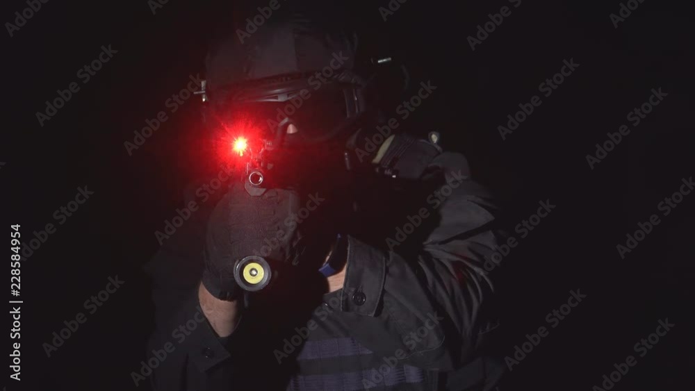 Automatic with laser sight. The soldier holds a laser sight on the ...