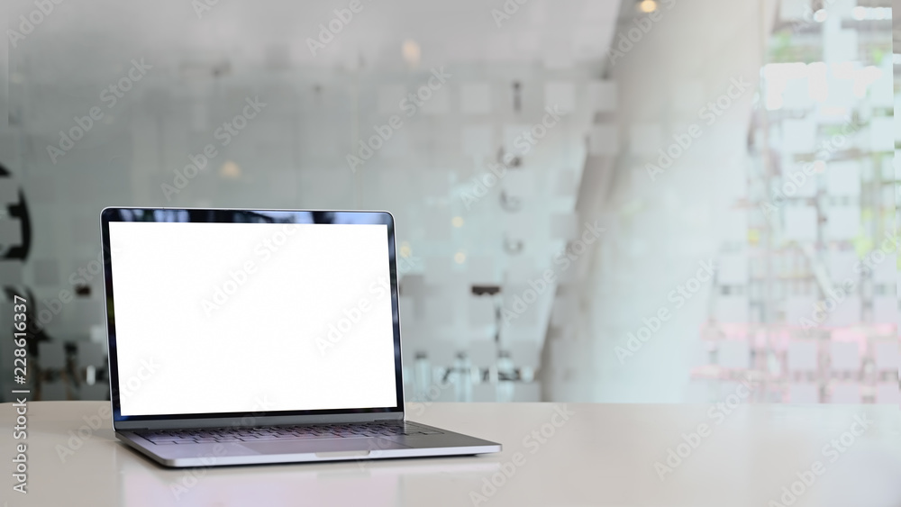 Laptop showing blank with screen on table in office. Stock Photo ...