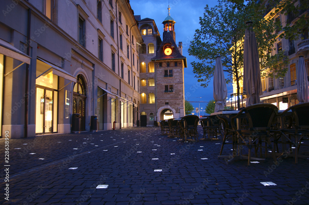 Geneva, Switzerland, one of the city streets at night with glowing ...