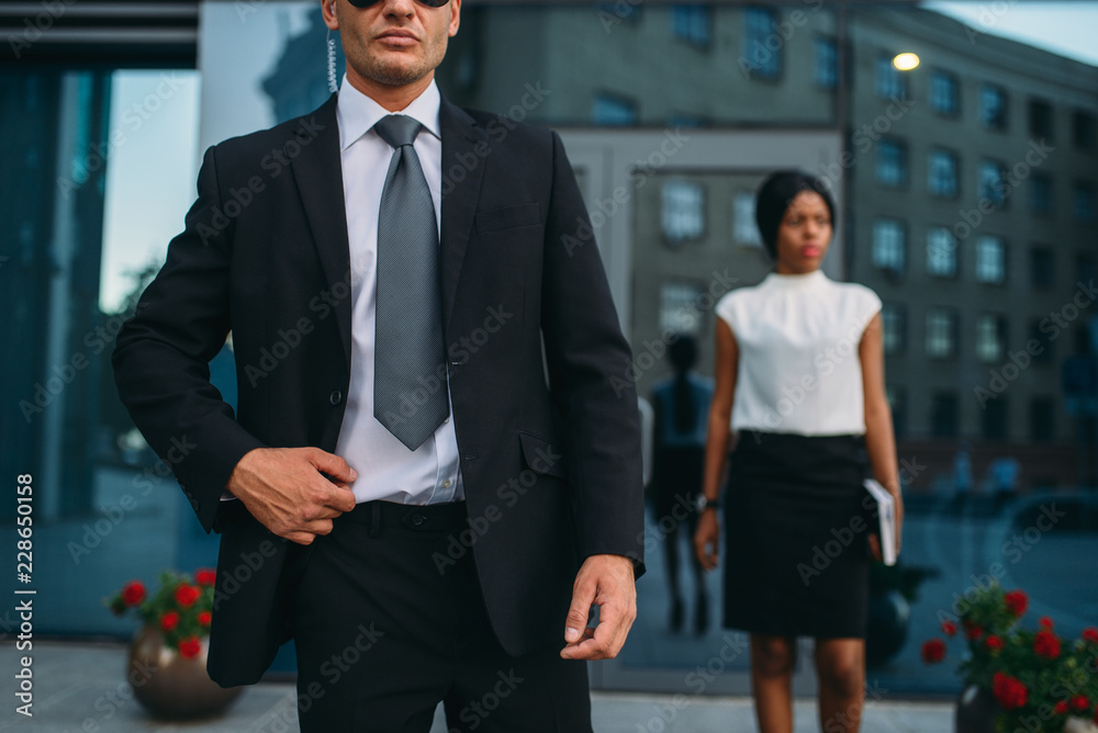 Bodyguard in suit and sunglasses, female VIP Stock Photo | Adobe Stock