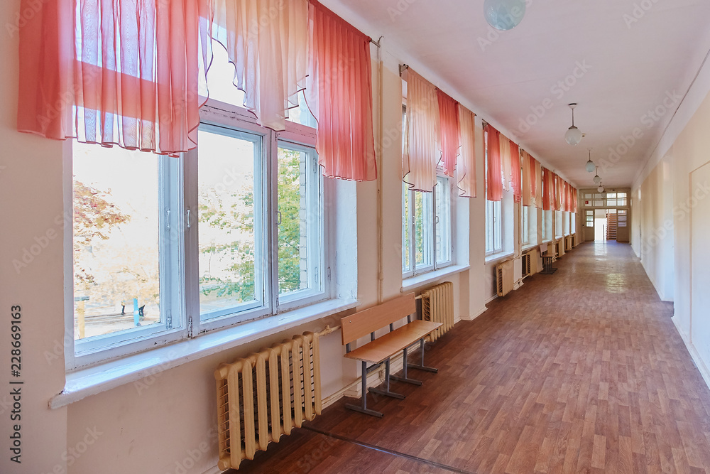Vintage corridor inside the school building. With cast iron batteries ...