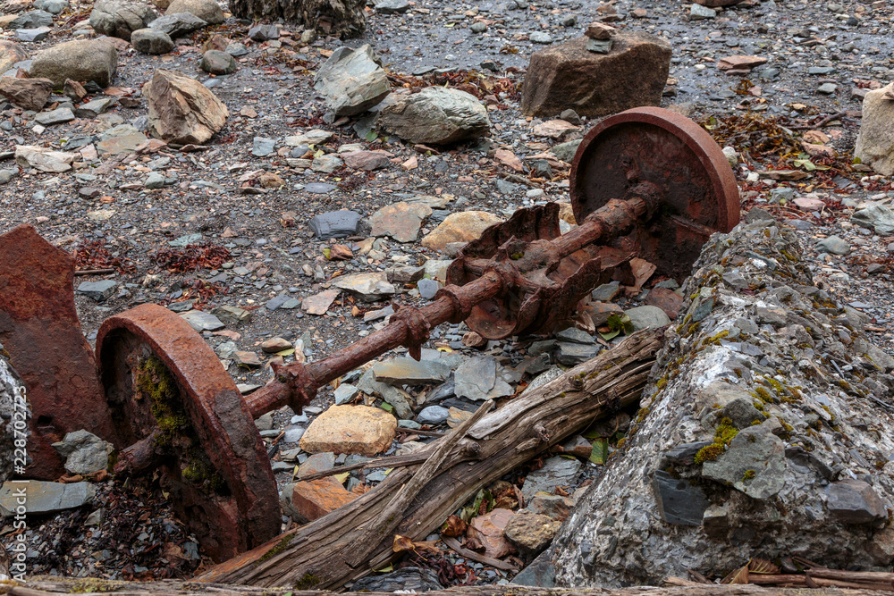 Old rusty wheels on the beach near the Treadwell mine historic park in ...
