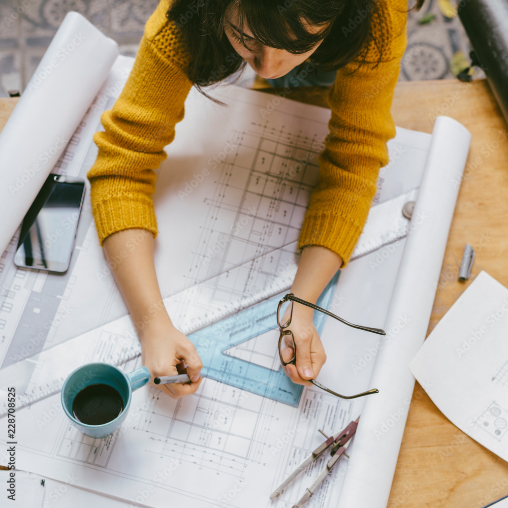 Top view of architect woman working on architectural project for ...