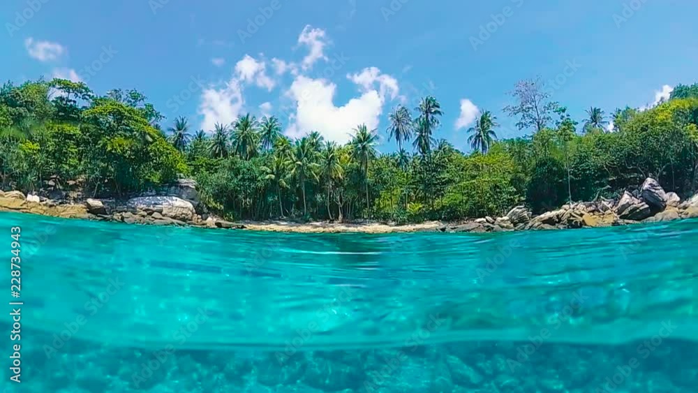 Half and half underwater shoot near the beach with turquoise water and ...