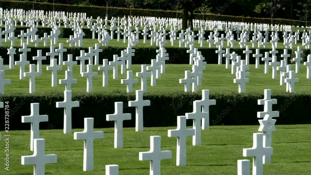 Zoom in-Tiers of White crosses on grass field at the WWII American ...