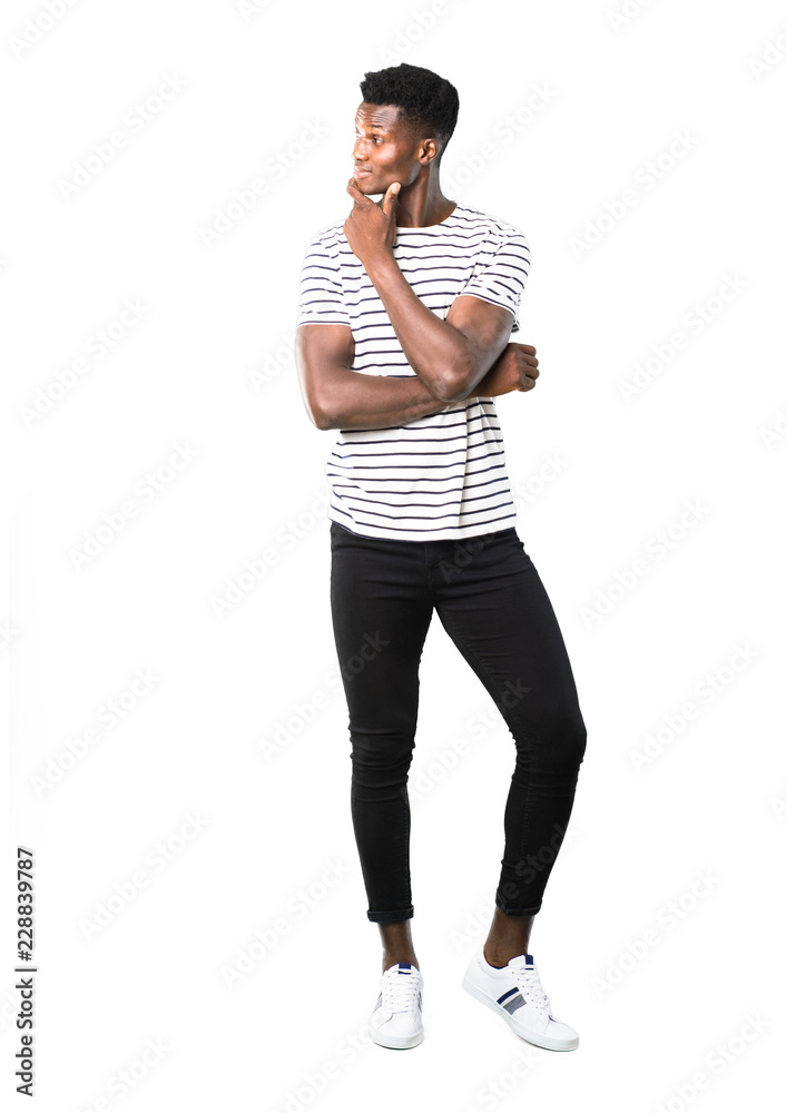 Full body of Dark skinned man with striped shirt standing and looking ...