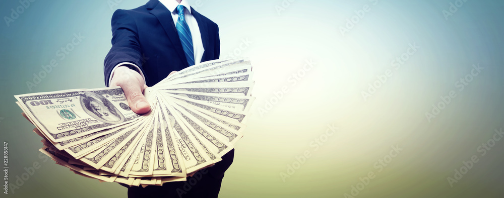 Business man displaying a spread of cash Stock Photo | Adobe Stock