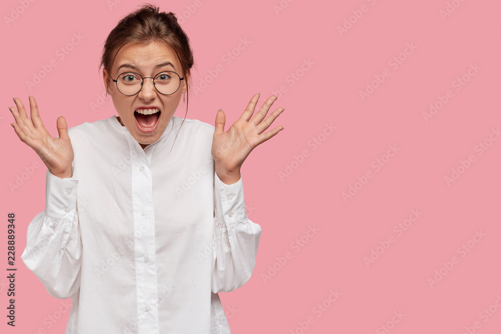Stop yelling at me! Pissed emotive dark haired woman spreads palms, has ...