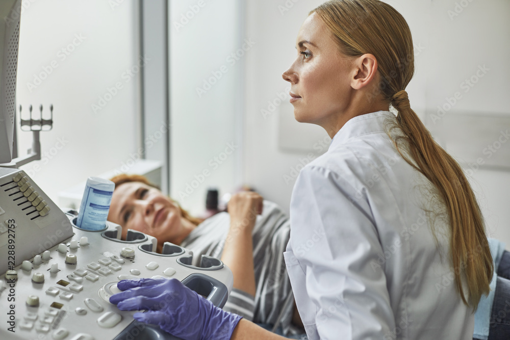 Side view portraits of gynecologist in white lab coat and sterile ...