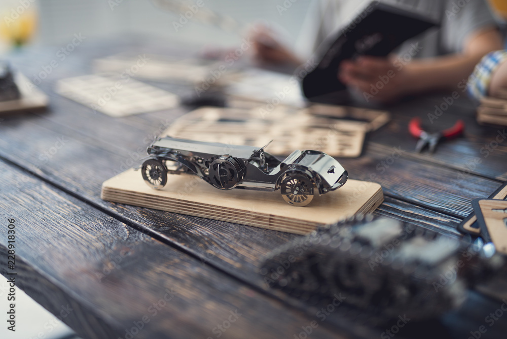 Detailed toys. Unusual metal mechanisms being placed on the table ...