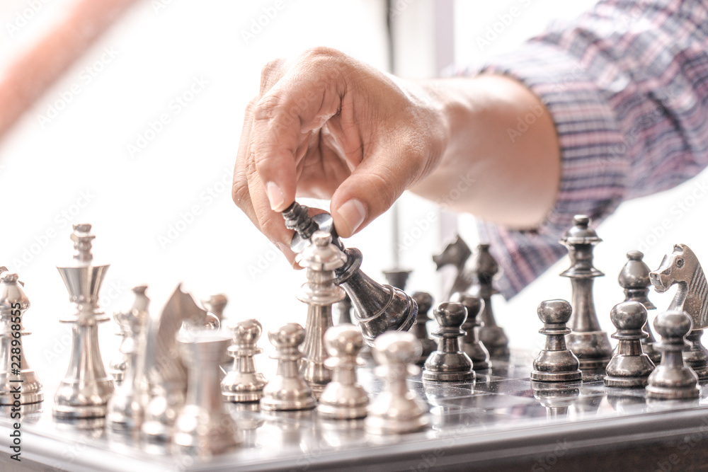 Hand of businessman moving chess figure . strategy, chess board game ...