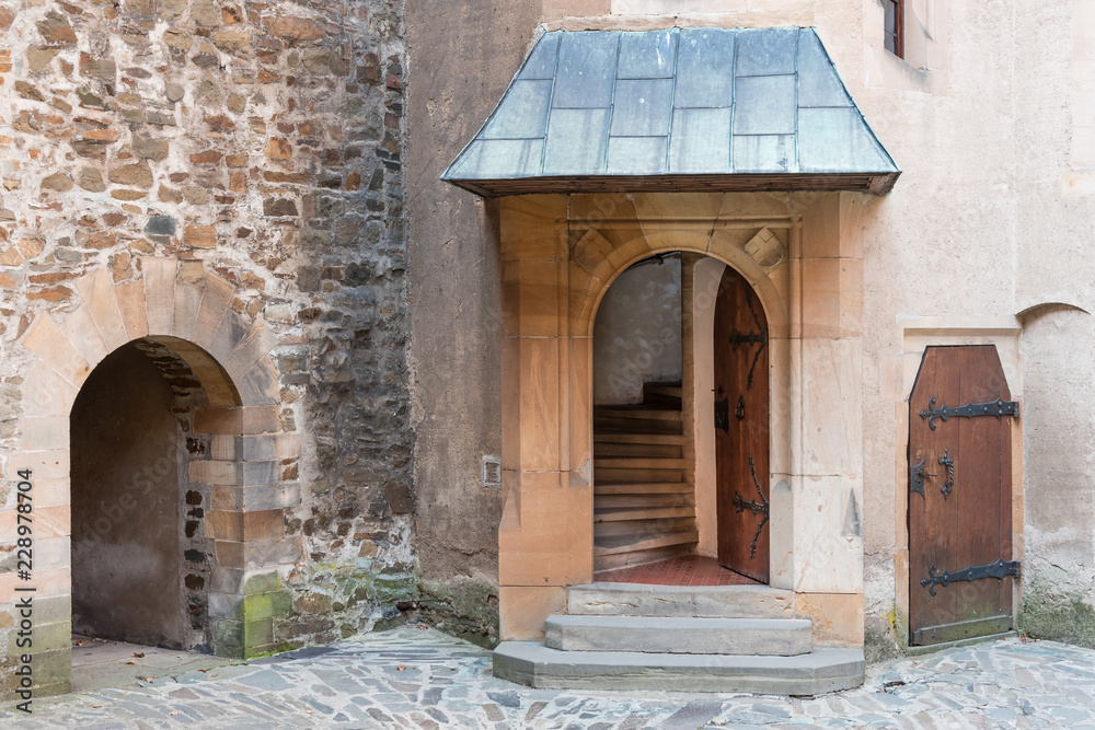 Old wall and the side door in the medieval castle in Bouzov. Stone ...