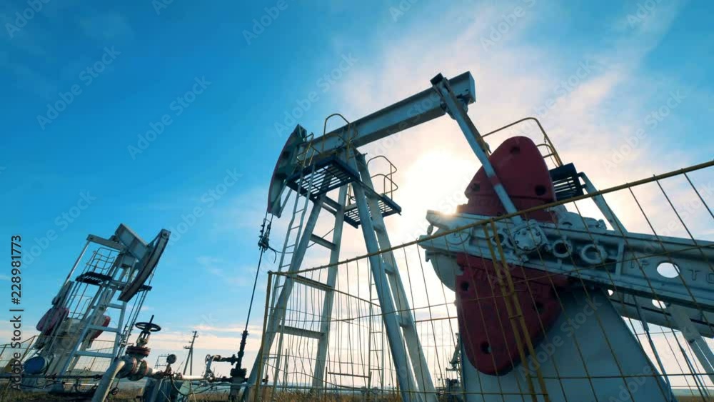 Modern oil derricks, oil rigs, petroleum rigs in work. Fossil Fuel ...