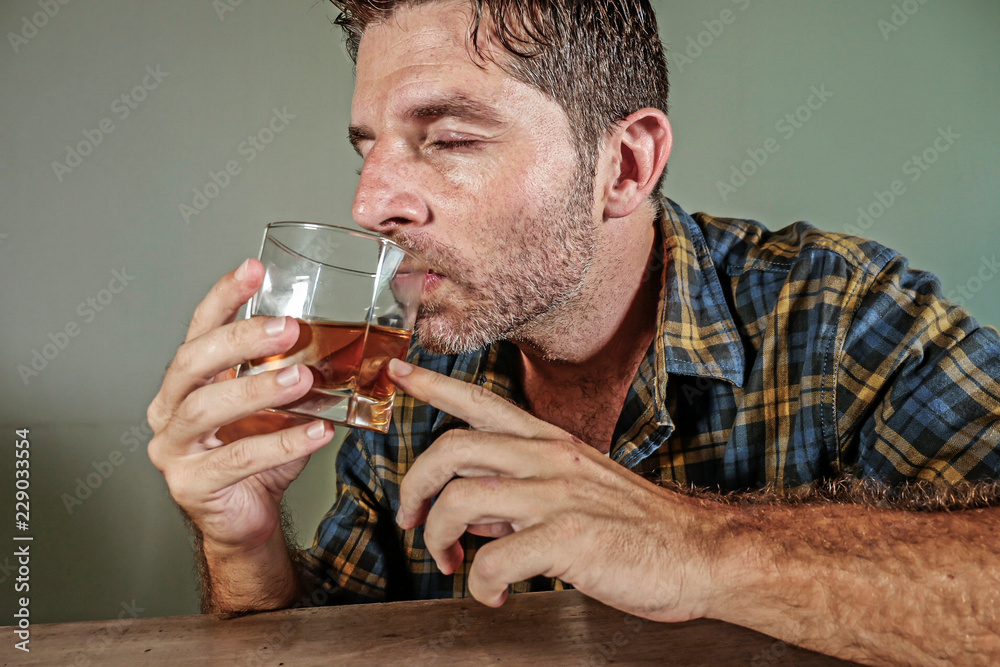 young attractive wasted and depressed addict and alcoholic man with ...