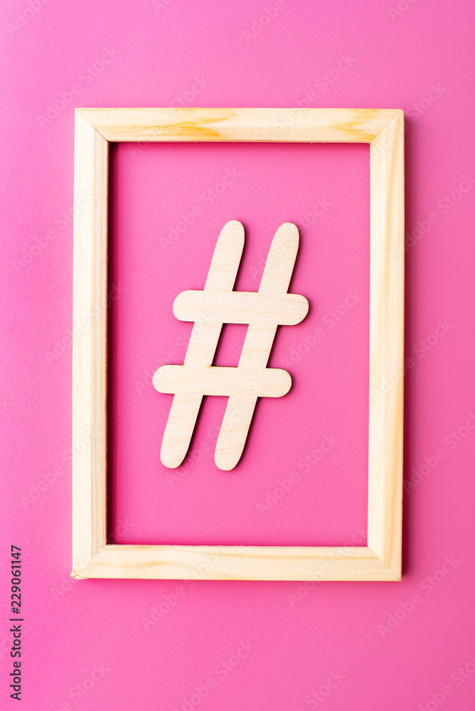 Hashtag sign made of wooden material in frame on pink background Stock ...