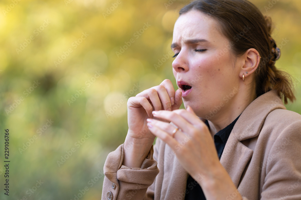 Young woman coughing or sneezing Stock Photo | Adobe Stock