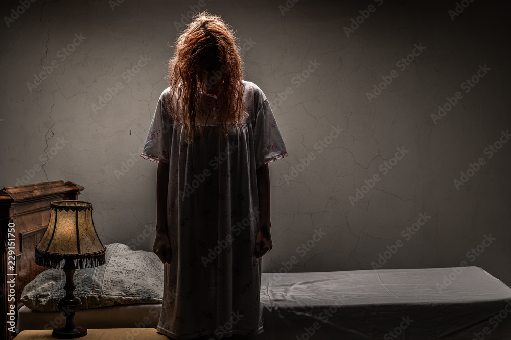 Scary woman possessed by devil in the bed. Exorcism of priest. Stock ...