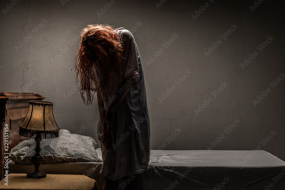 Scary woman possessed by devil in the bed. Exorcism of priest. Stock ...