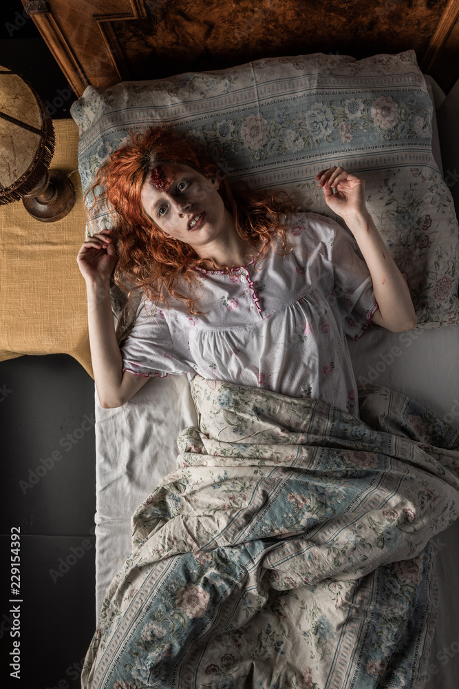 Scary woman possessed by devil in the bed. Exorcism of priest. Stock ...