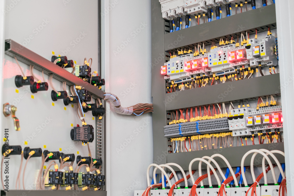 An open fuse box is on the wall in the basement. High voltage ...