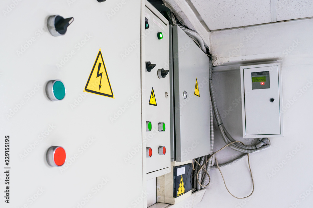 A few fuse boxes are installed on the wall in the basement. High ...