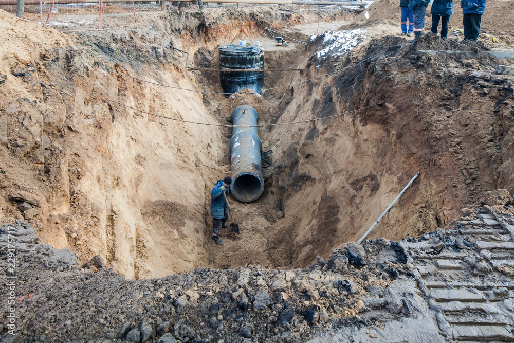sewer pipe in the trench . Urban construction of a trench in the ground ...