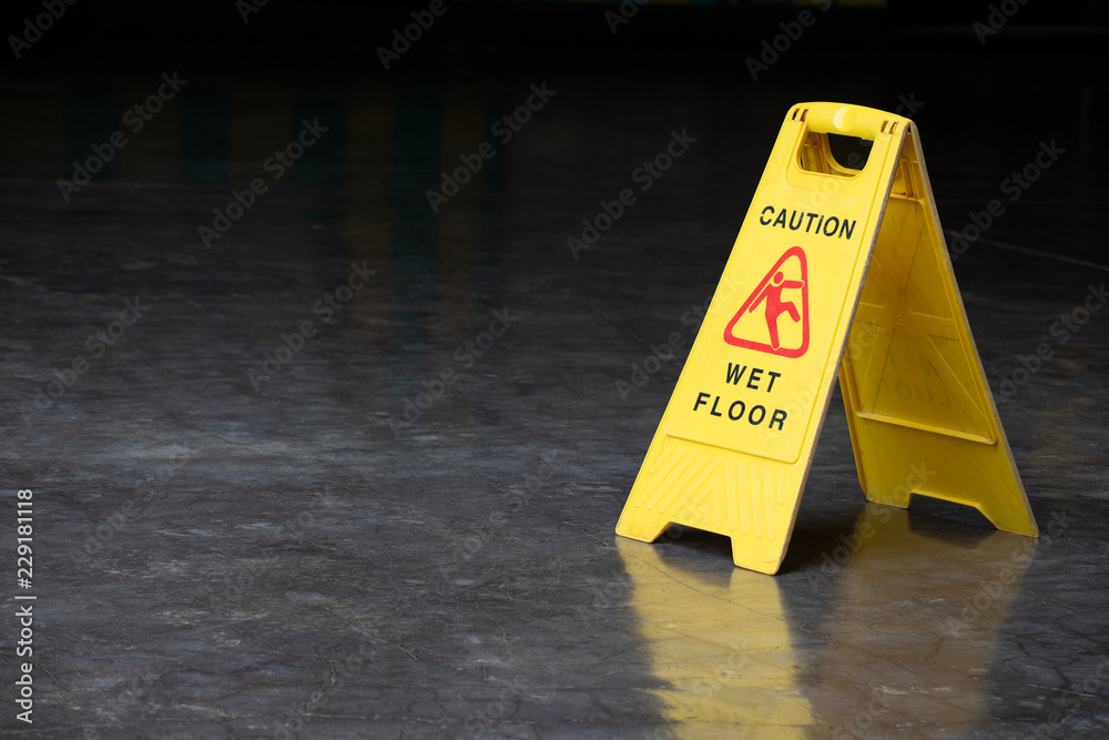 wet floor sign on cement ground. yellow plastic warning sign. Stock ...